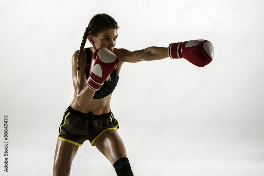 Fit caucasian woman in sportswear boxing isolated on white studio ...