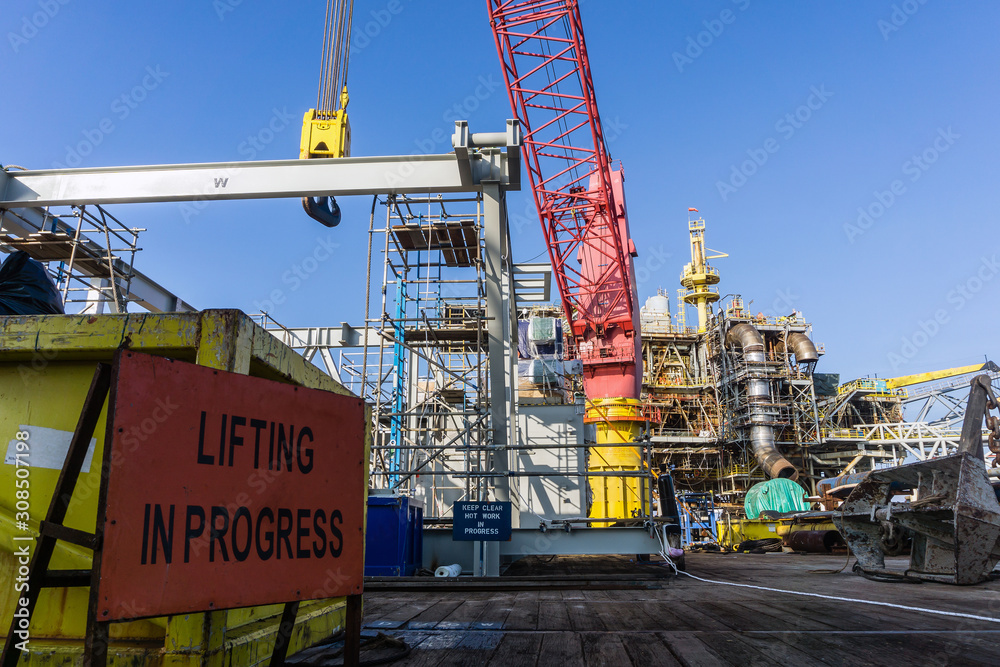 Heavy lift operations on board a construction work barge at oil field ...