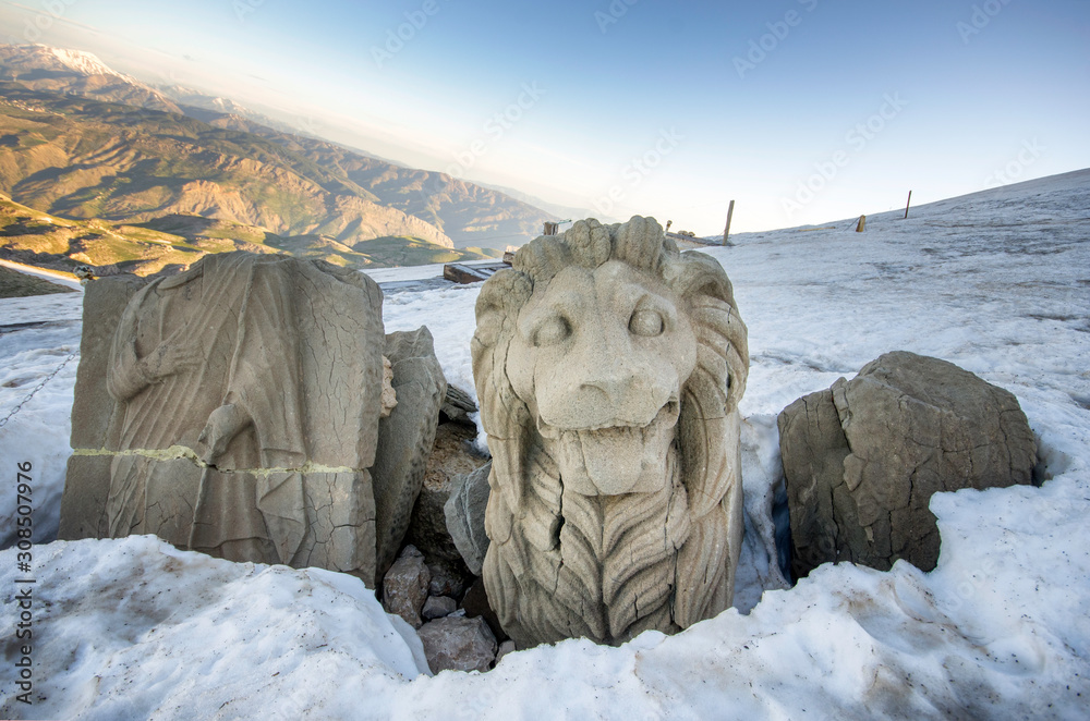Statue of lion figure in snow at western terrace ruins of Nemrut ...