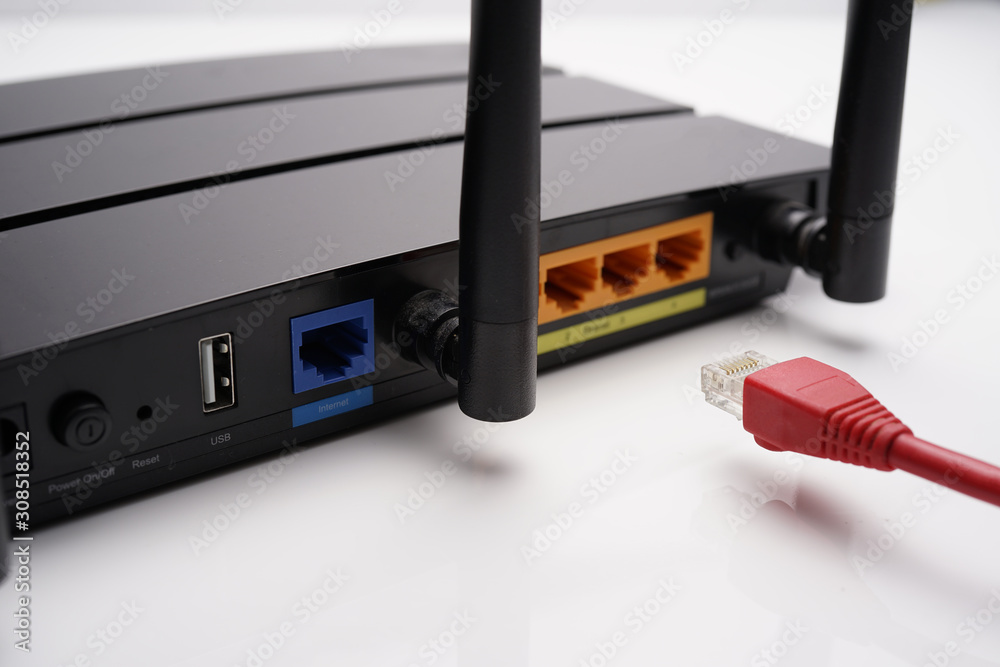 Backside view of dual band wifi router with cat-6 cable connected to ...