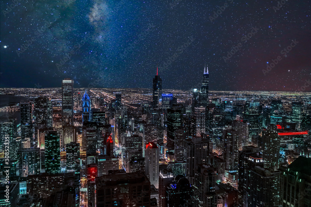 An aerial view of Chicago, Illinois at night time under a starlit sky ...