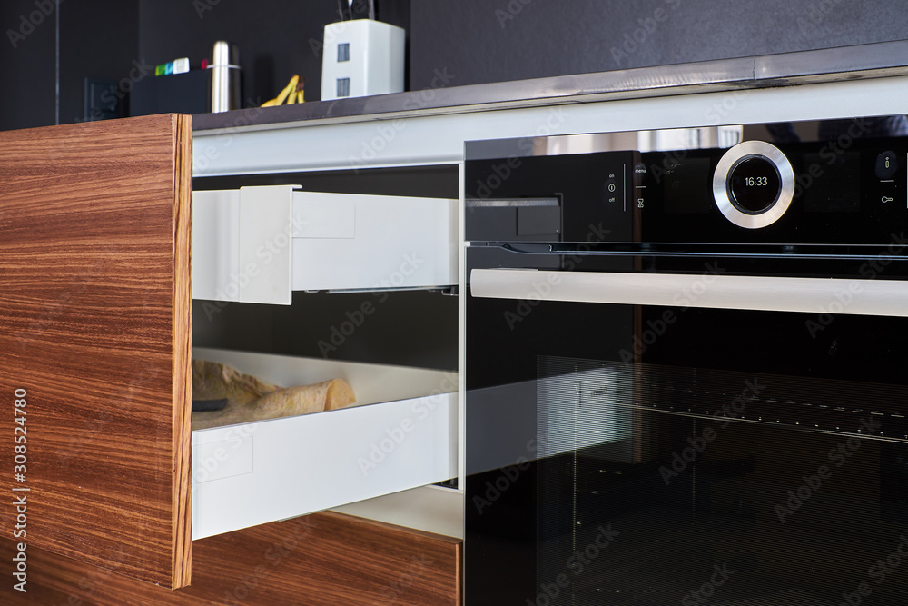 drawers in high-tech kitchen with facades made of walnut veneer Stock ...