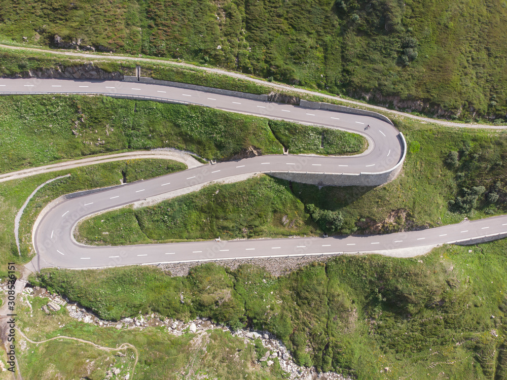 Birds eye view of a cyclist speeding down a curvy Swiss highway Stock ...