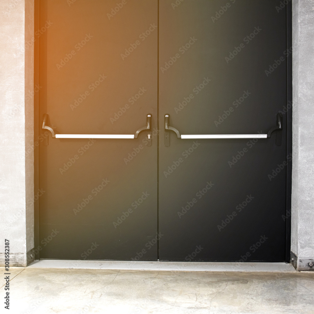 Black metal doors. Closed Emergency Exit Door. Evacuation from shopping ...