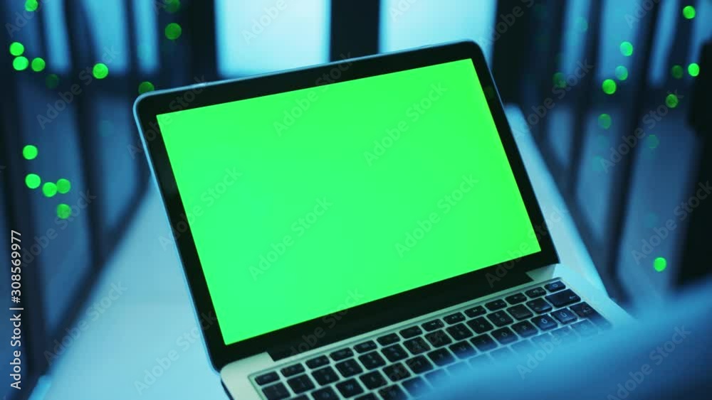 Over the shoulder professional IT engineer keyboarding on laptop mock ...