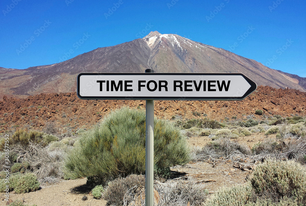 Road sign with TIME FOR REVIEW text under volcano background Stock ...