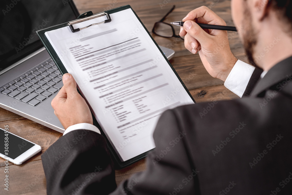 Employer filling candidate form sitting in office back view cllose-up ...