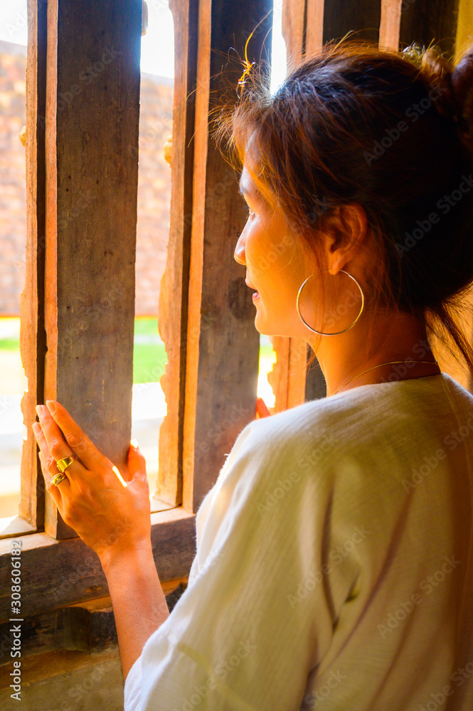 Thai woman in Thai native dress beside the window Stock Photo | Adobe Stock