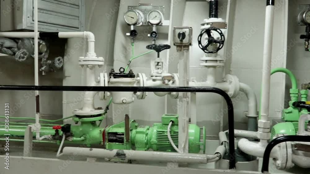 multiple closed conduits with curved pipes and green pumps stretch ...