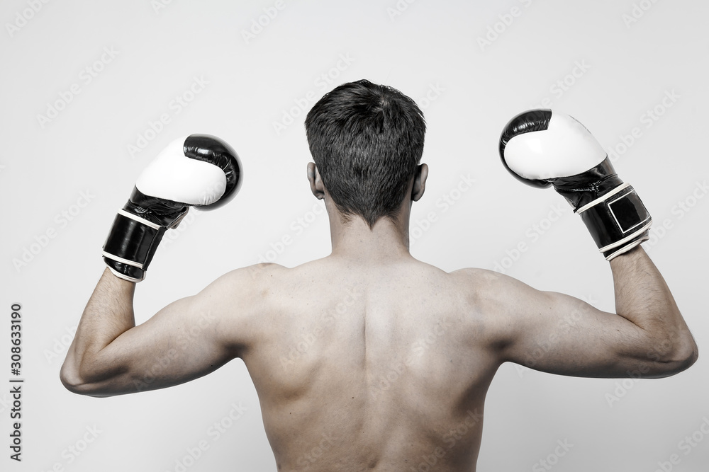 View from the back of a white brunet man raising his arms up in boxing ...