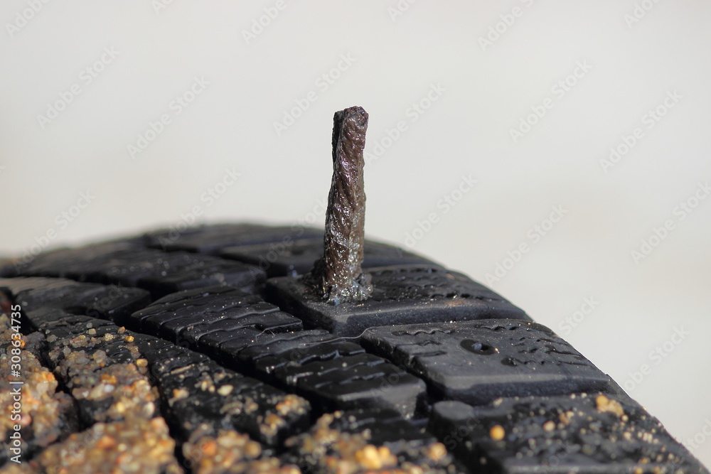 Repaired wheel with repair thread compound on a car winter tyre close ...