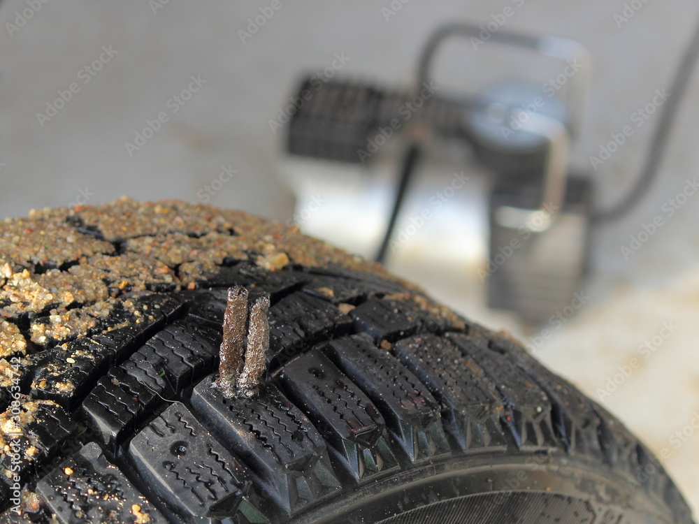 Wheel repair thread compound on a car winter tyre close-up on portable ...