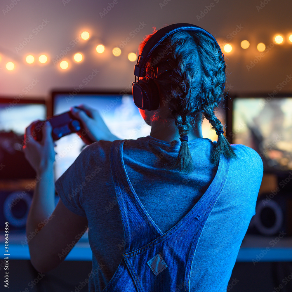 The girl emotionally plays video games with a headset, and a joystick ...