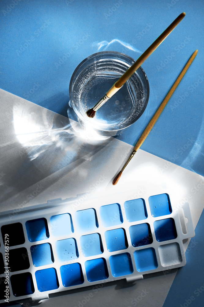 Workplace of an watercolor artist-painter. Blue background, new ...