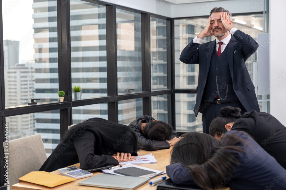 Moody or stress boss with lazy or tired teamwork sleep on meeting table ...