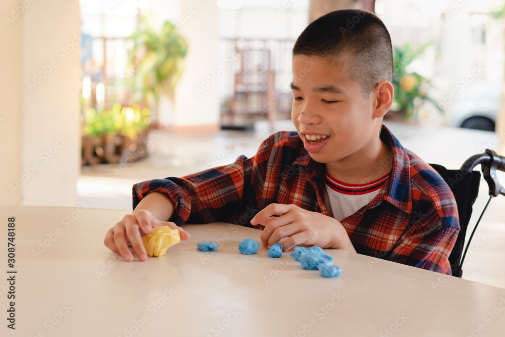 Foto Stock Asian disabled child on wheelchair molding clay, Fun and ...