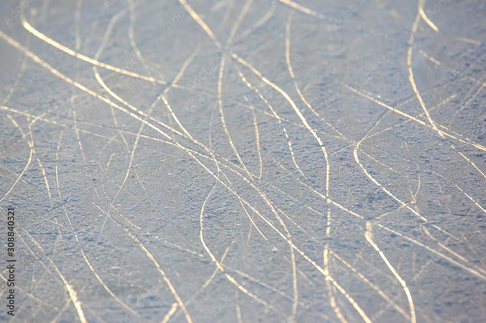 bright traces of ice skating on an ice rink. background and texture ...