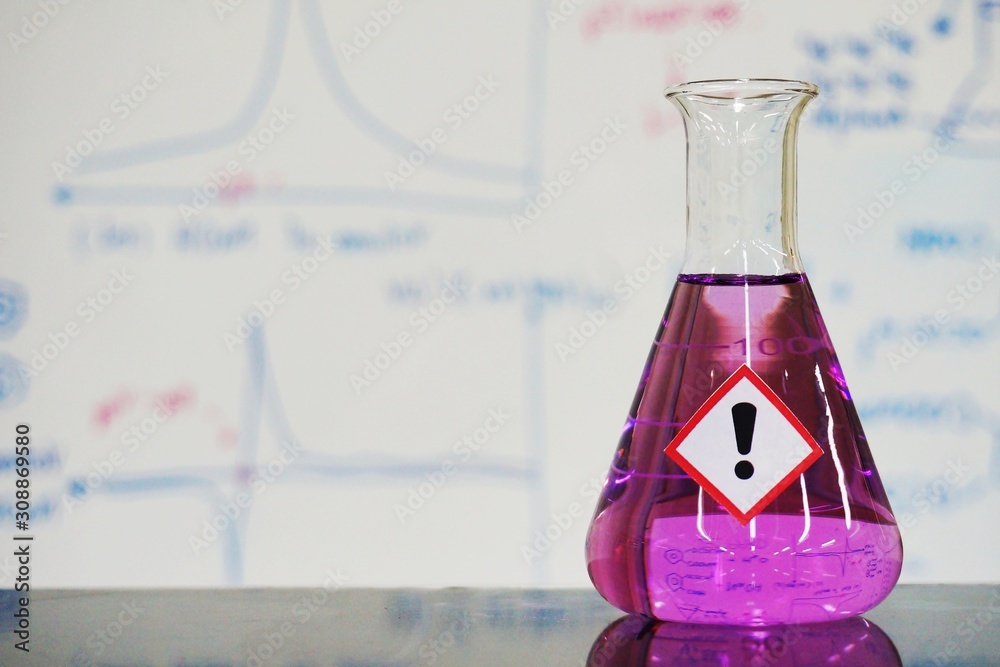 Erlenmeyer flask with Magenta pink liquid and chemical hazard warning ...