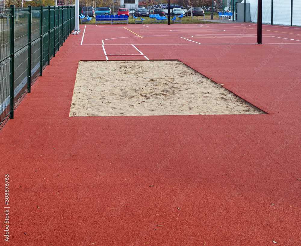 Sand pit for the long jump competition at the school athletics stadium ...