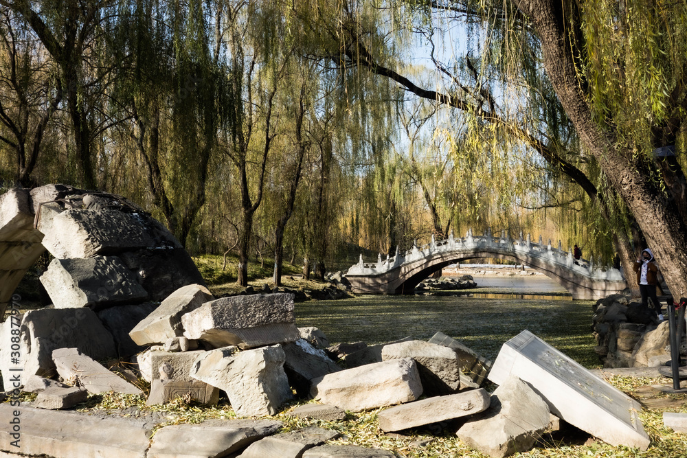 Arch stone bridge and its reflection in water in Yuanmingyuan Imperial ...