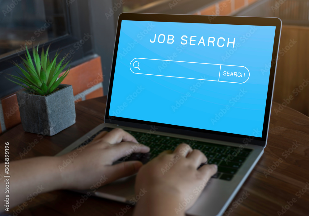 Business woman's hands with Laptop computer are looking for a new job ...