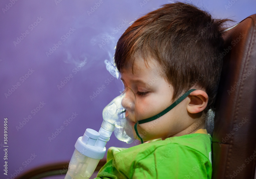 Little boy in a mask, treatments respiratory tract with a nebulizer at ...