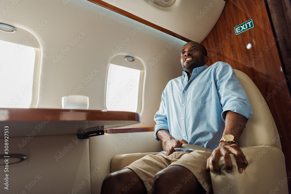 terrified african american man flying in private jet Stock Photo ...