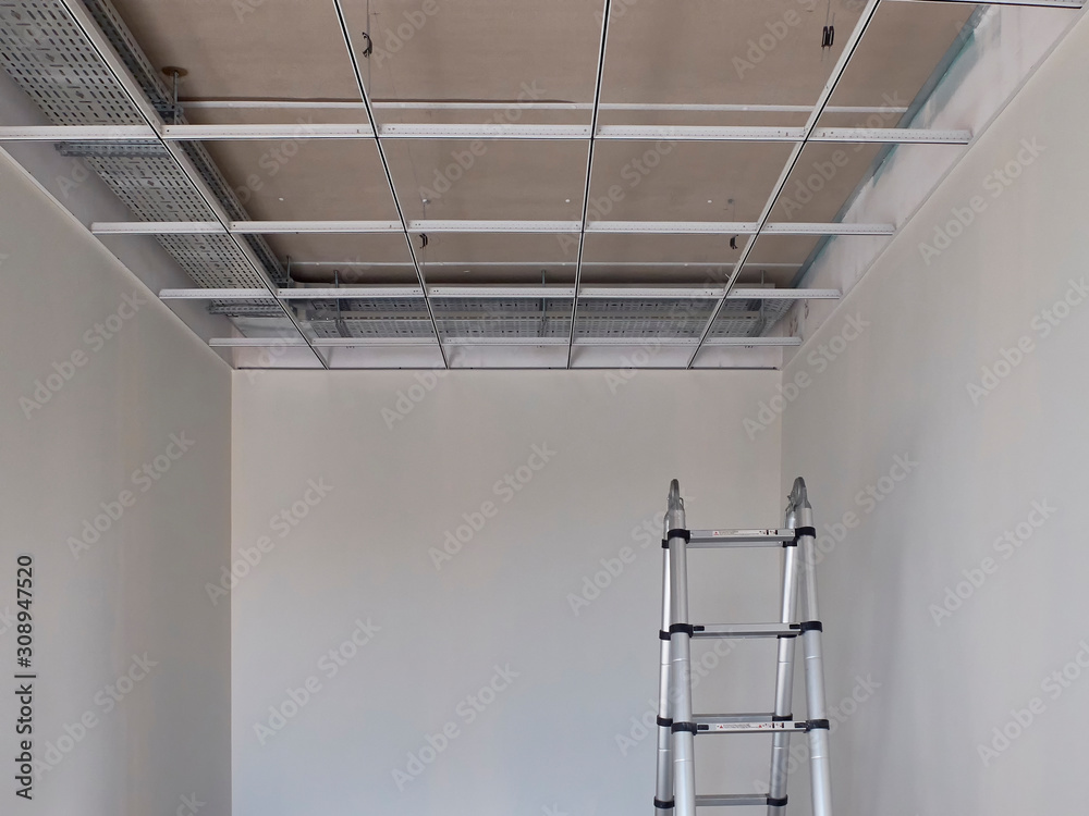 Metal frame of suspended ceilings and stepladder. Making of false ...
