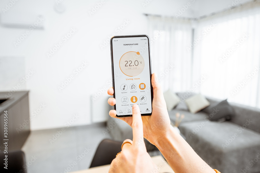 Controlling home heating temperature with a smart home, close-up on ...