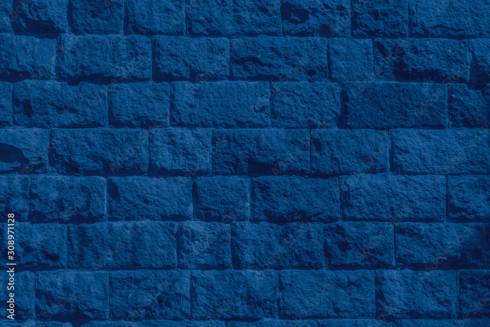 Color of the year 2020 classic blue. Stone brickwork texture of old ...