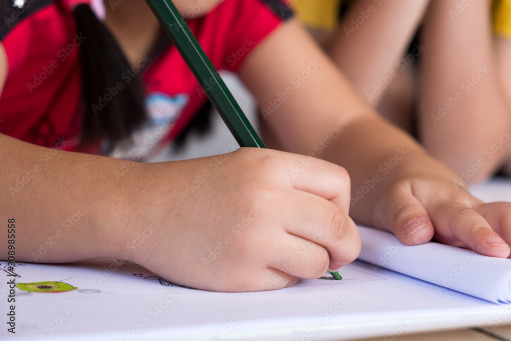 kids doing homework writing and color in their notebook at home ...