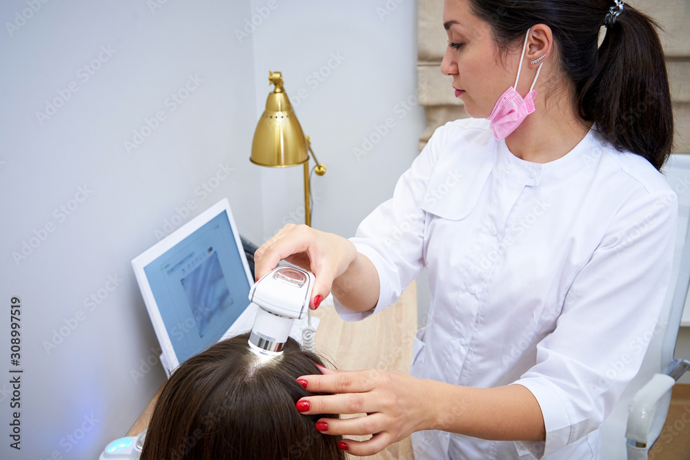 Diagnostic microscopic examination of hair and scalp. Stock Photo ...