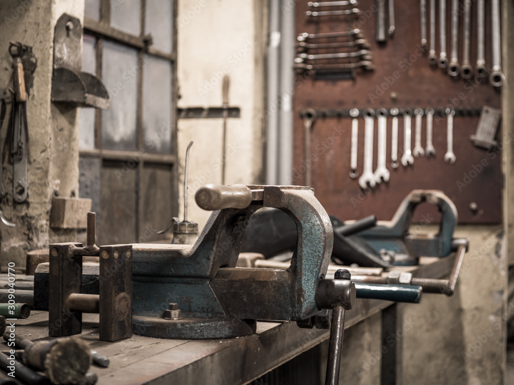 Old workshop with a workbench with a vise and many types of tools Stock ...