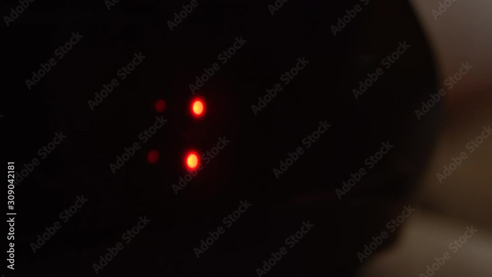 Close-up of black digital clock screen showing 5.00. Blinking red ...