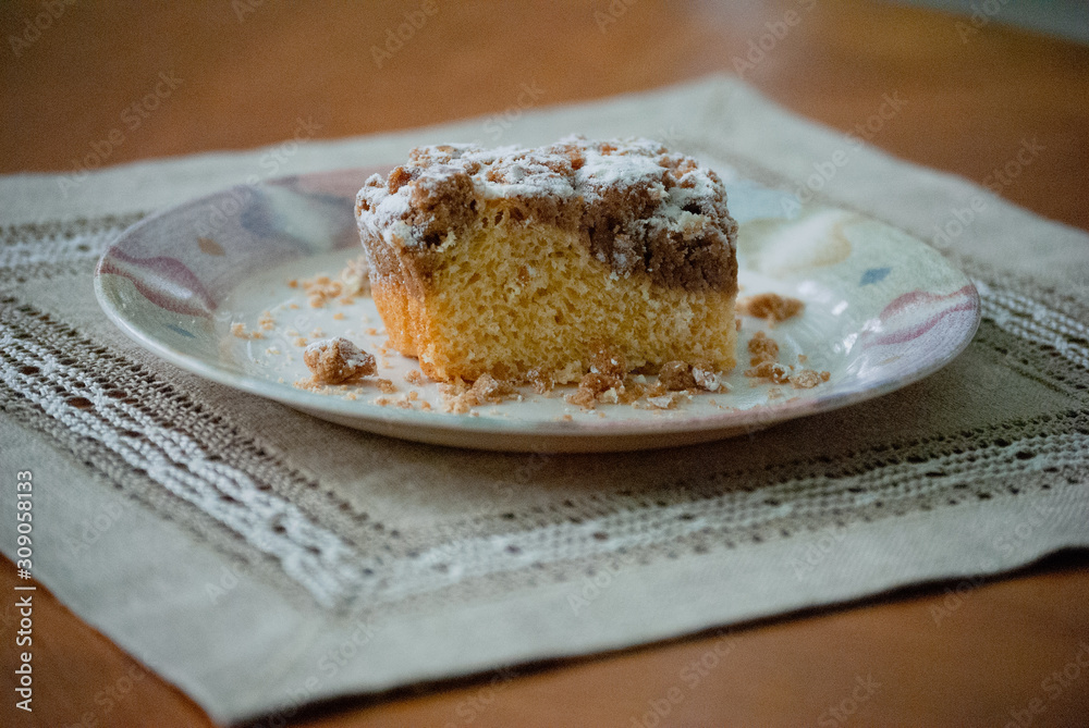 Single piece of coffee crumb cake, streusel, on a plate with a bokeh ...