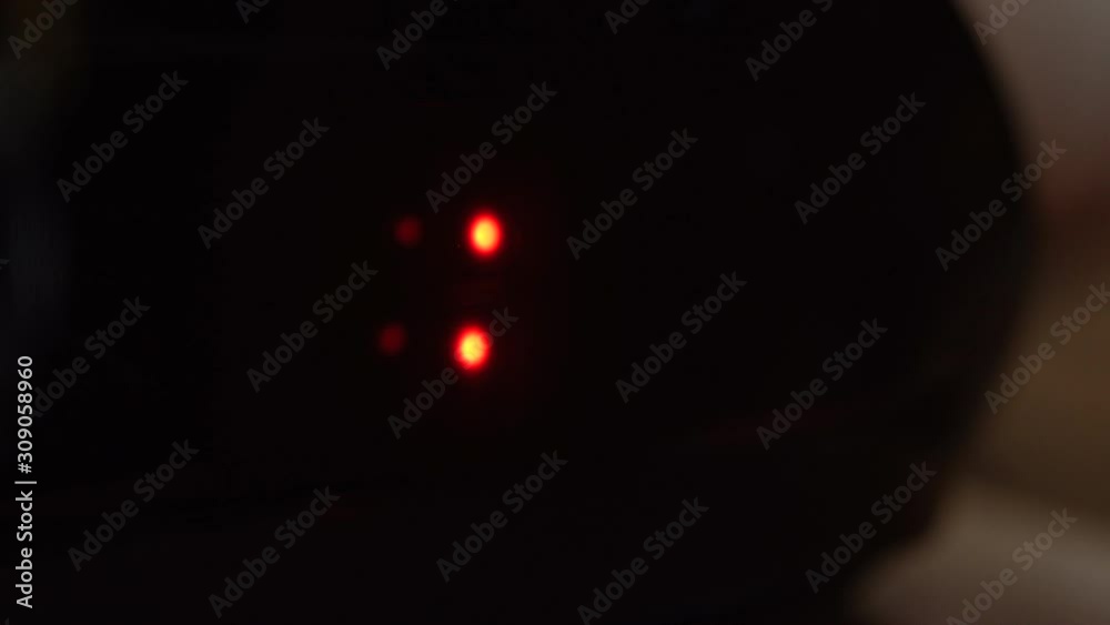 Close-up of black digital clock screen showing 14.00. Blinking red ...