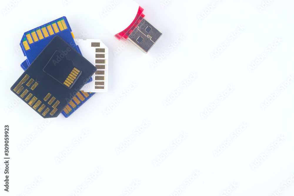 memory cards of different sizes lying on top of each other on a white ...
