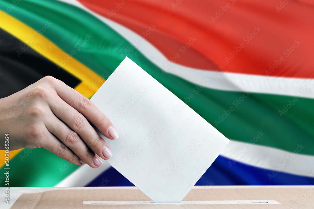 South Africa election concept. Side view woman putting a ballot in a ...