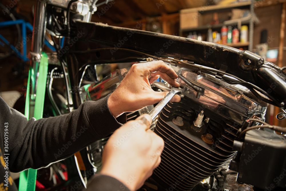 mechanic is making repairs to a motorcycle Stock Photo | Adobe Stock