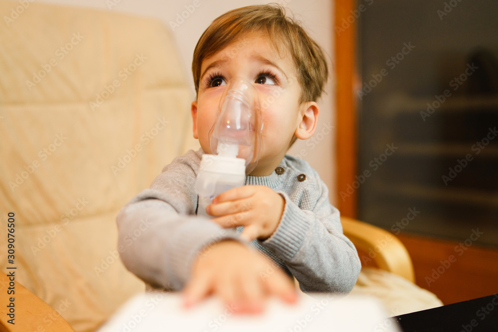 Little small sick boy using steam inhaler nebulizer mask inhalation at ...