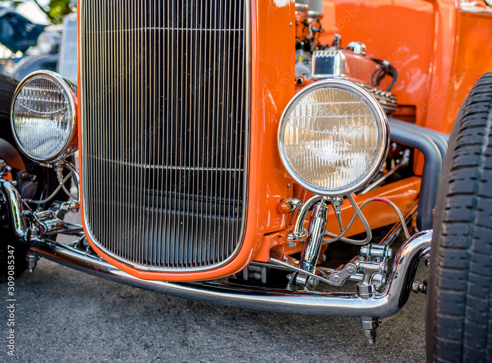 Epic vintage orange retro car with open wheel suspension and headlights ...