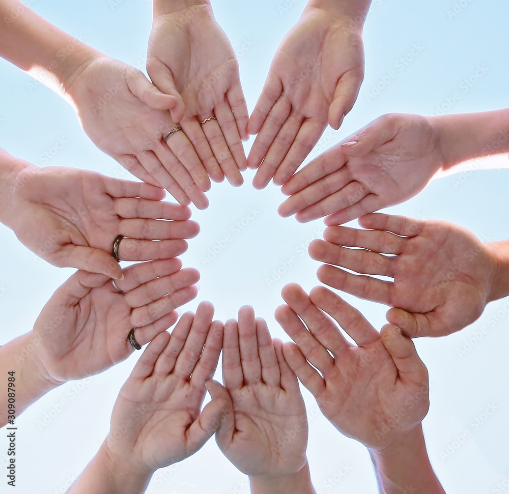 overhead view of a group of people making a circle shape with their ...