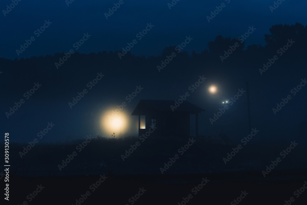cabin in the night fog. lonely shack at night. scary creepy house at ...