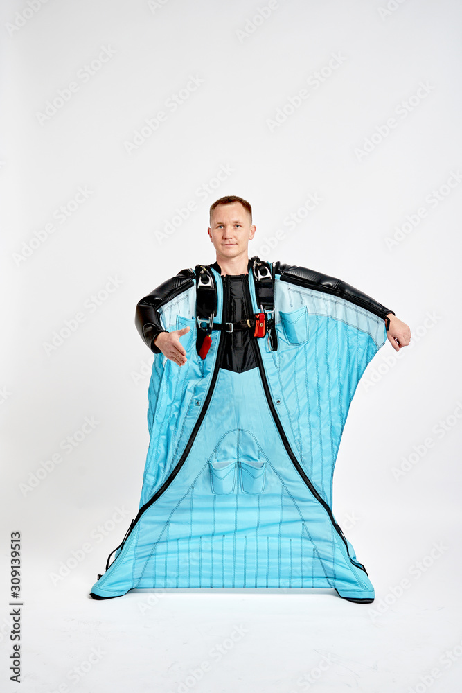 Greeting gesture. Men in wing suit shows greeting gesture with hands ...