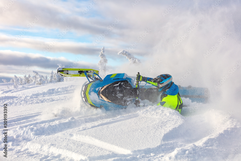 Foto de Pro snowmobiler makes a turn and lets a flurry of snow spray ...