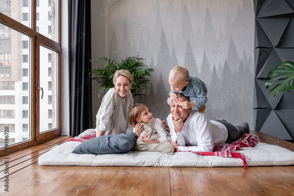 Positive friendly young family cheerful mom good-natured dad resting ...