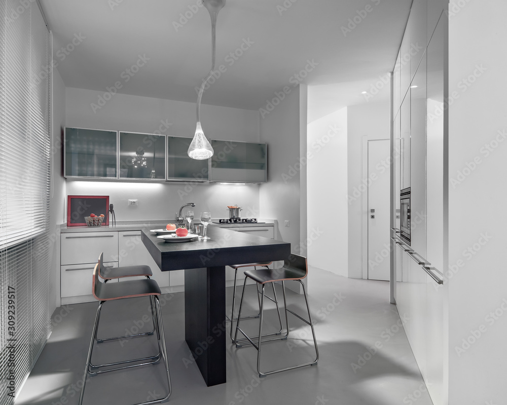inerior view of a modern kitchen in the foreground the kitchen island ...