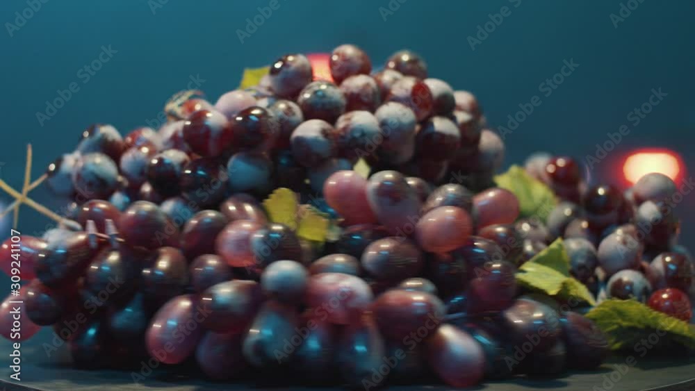 Bunch of big fresh ripe red grapes with drops of water on their surface ...
