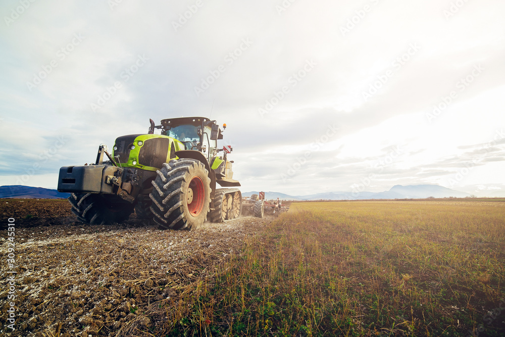 Modern tractor working on the farm, a modern agricultural transport ...