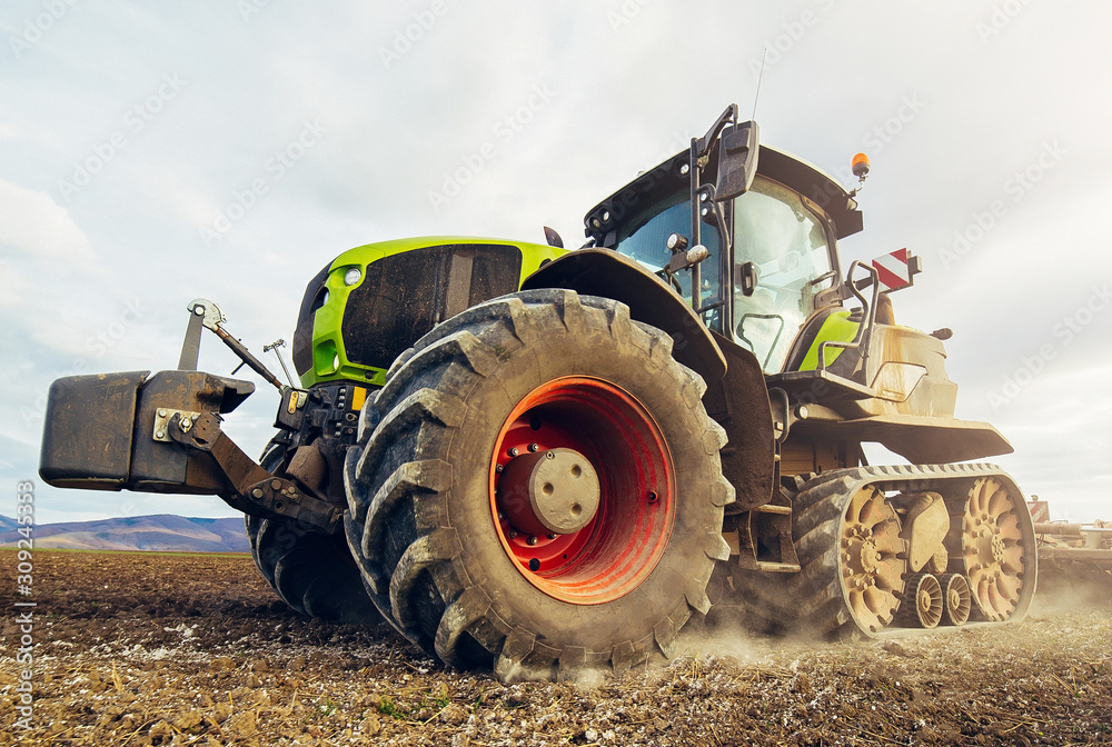 Modern tractor working on the farm, a modern agricultural transport ...